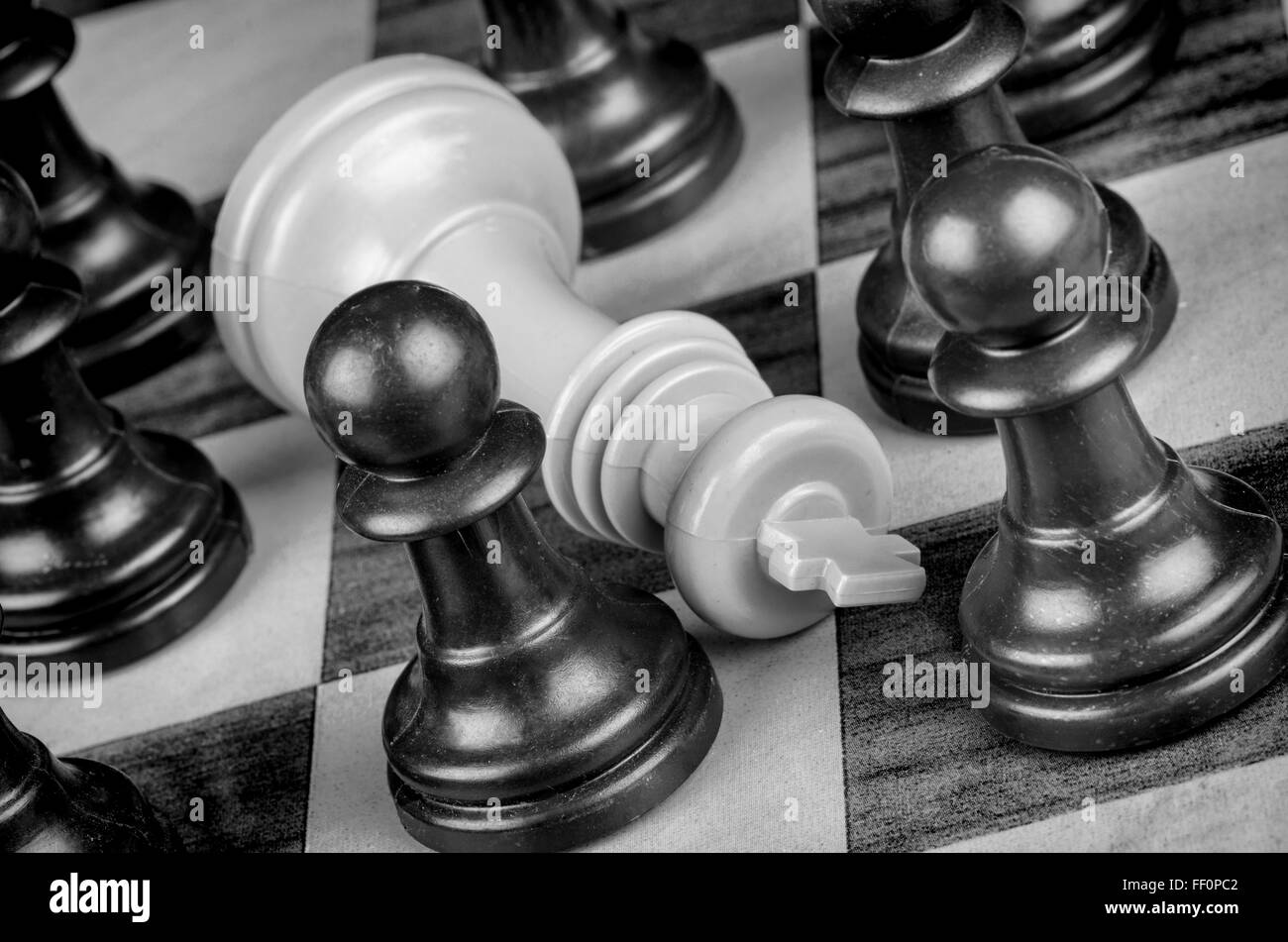 Pawns surrounding king, a social upheaval concept Stock Photo - Alamy