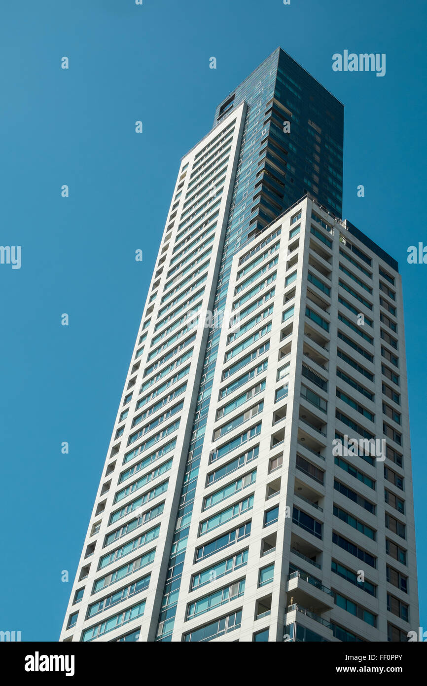 High rise building against blue sky background Stock Photo - Alamy