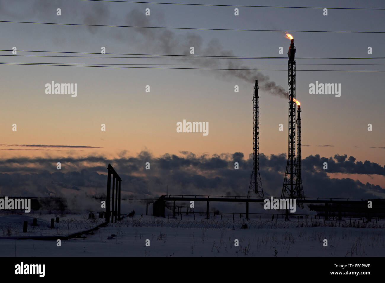 Refinery at sunset sky background. Frosty snowy winter evening Stock ...