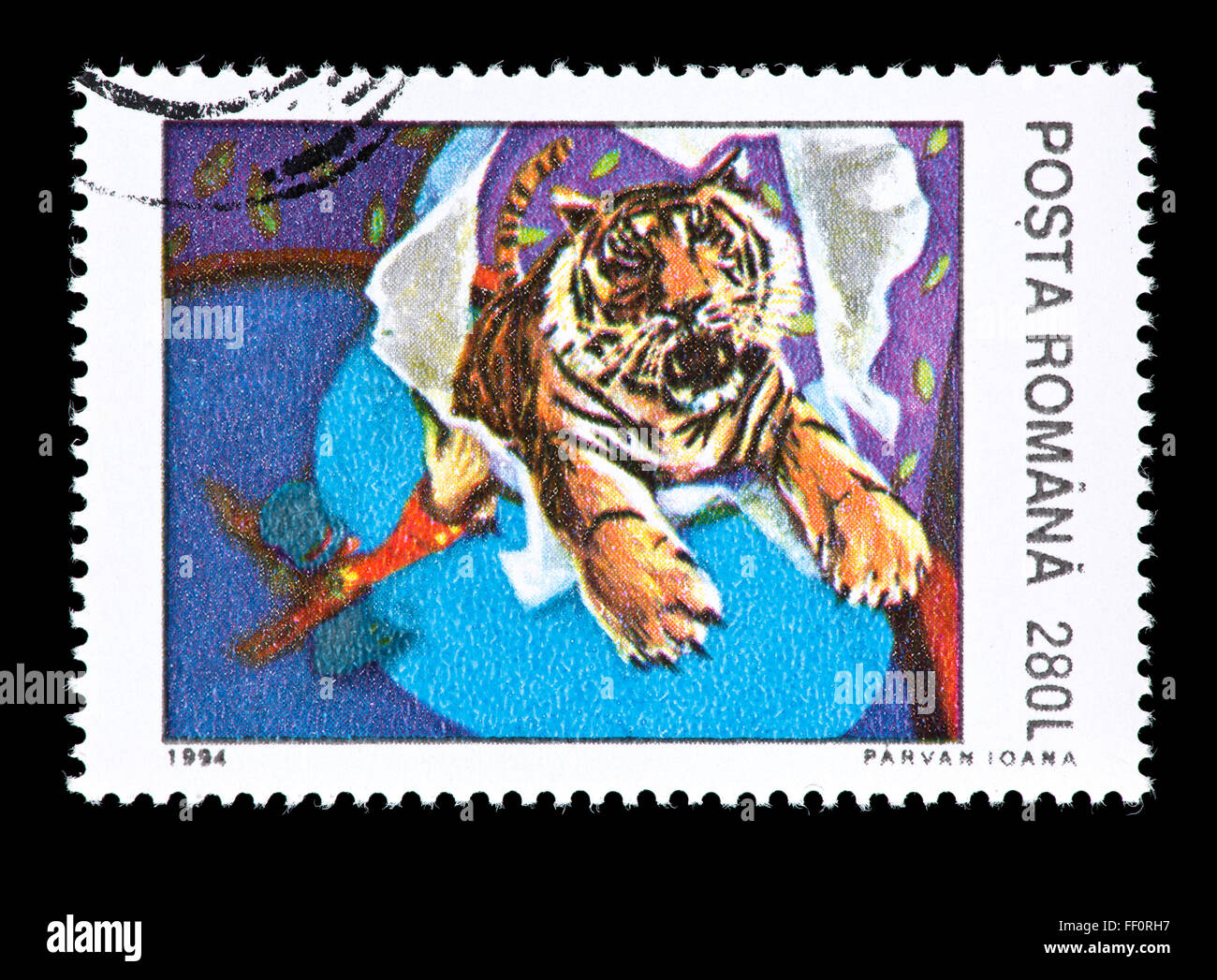 Postage stamp from Romania depicting a tiger jumping through a hoop ...