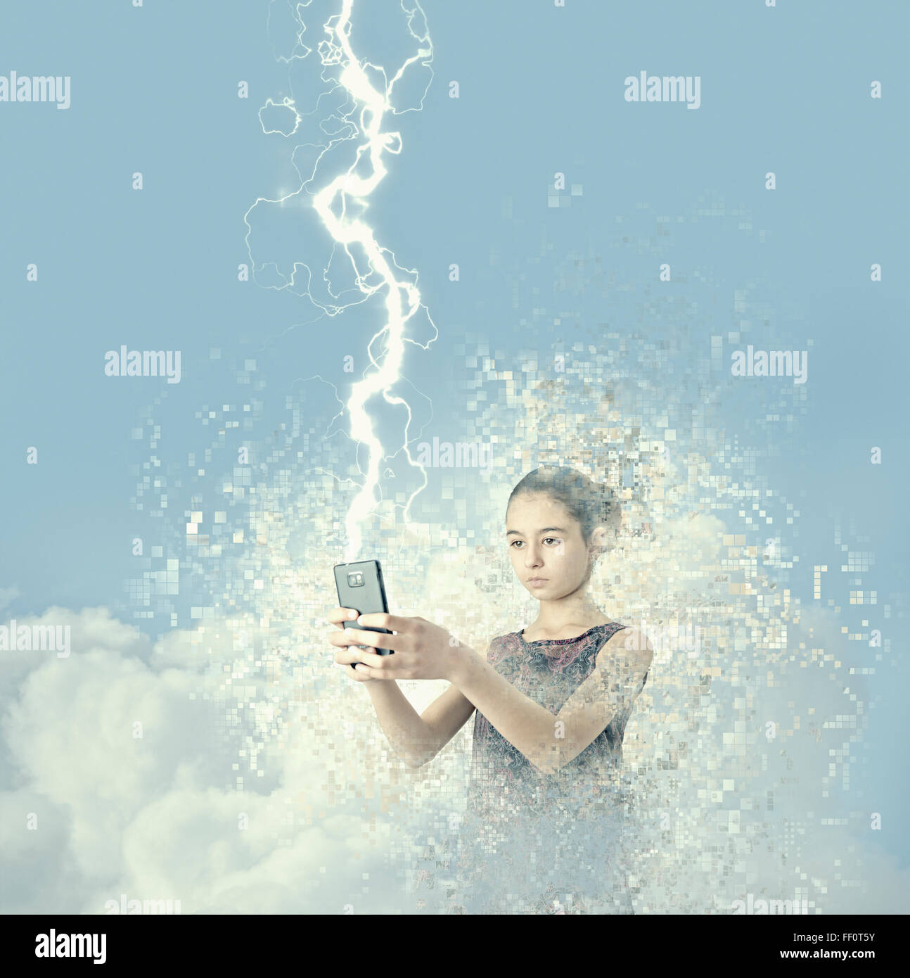 Mixed race girl holding cell phone in lightning Stock Photo - Alamy