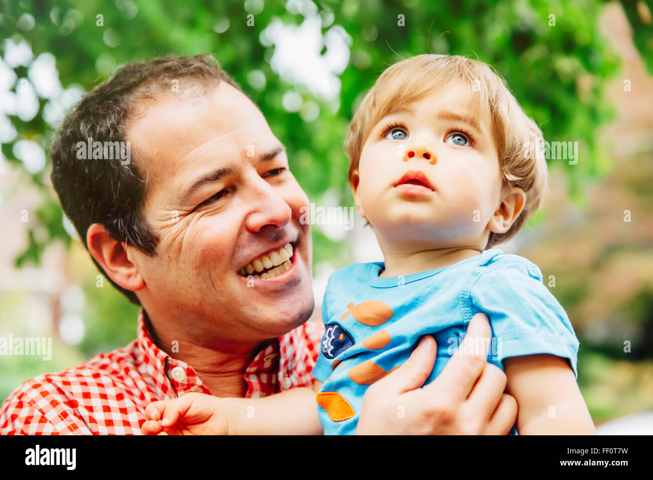 Father holding baby son outdoors Stock Photo - Alamy