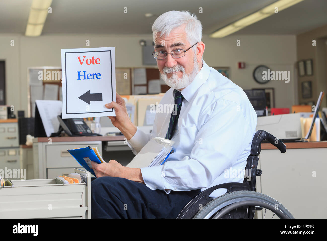 Caucasian businessman holding voting sign in office Stock Photo - Alamy