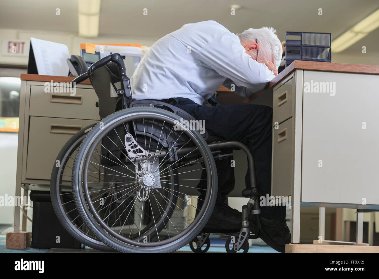 Caucasian businessman resting on office desk Stock Photo - Alamy