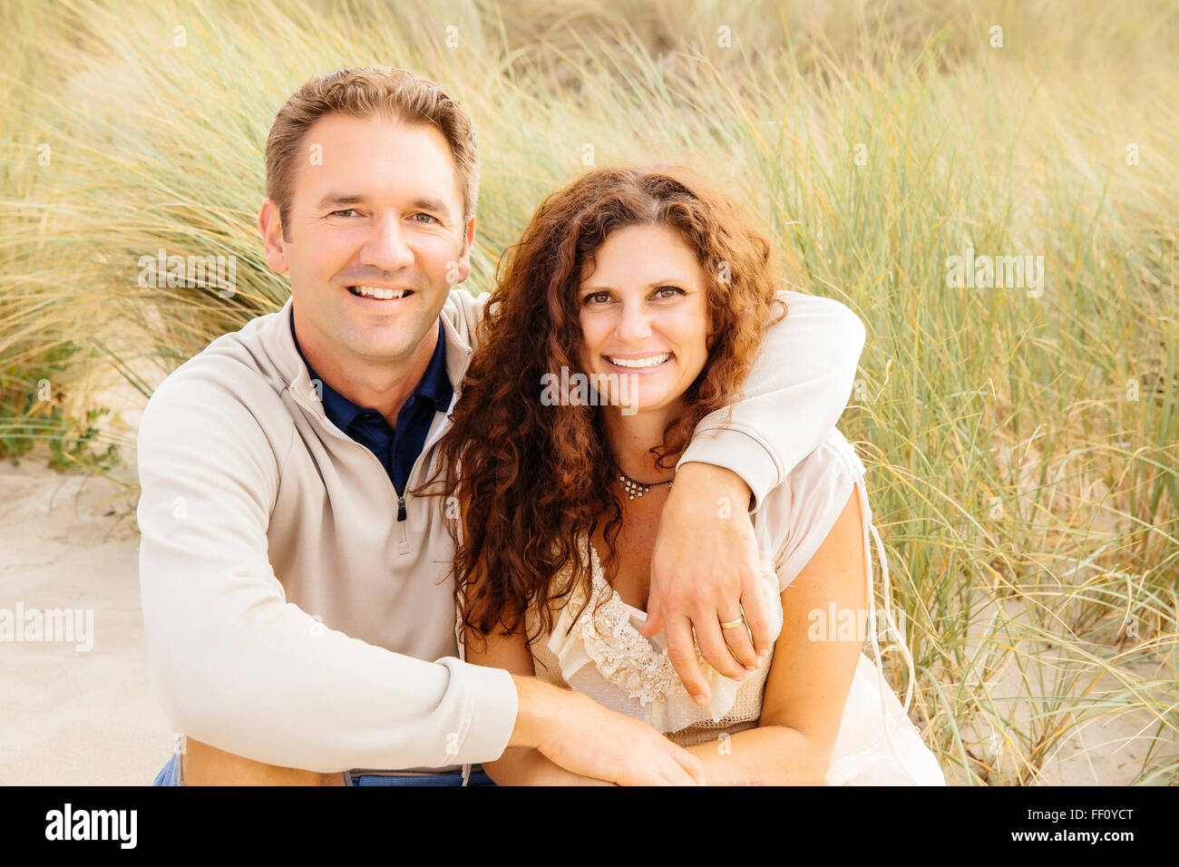 Caucasian couple smiling on beach Stock Photo - Alamy