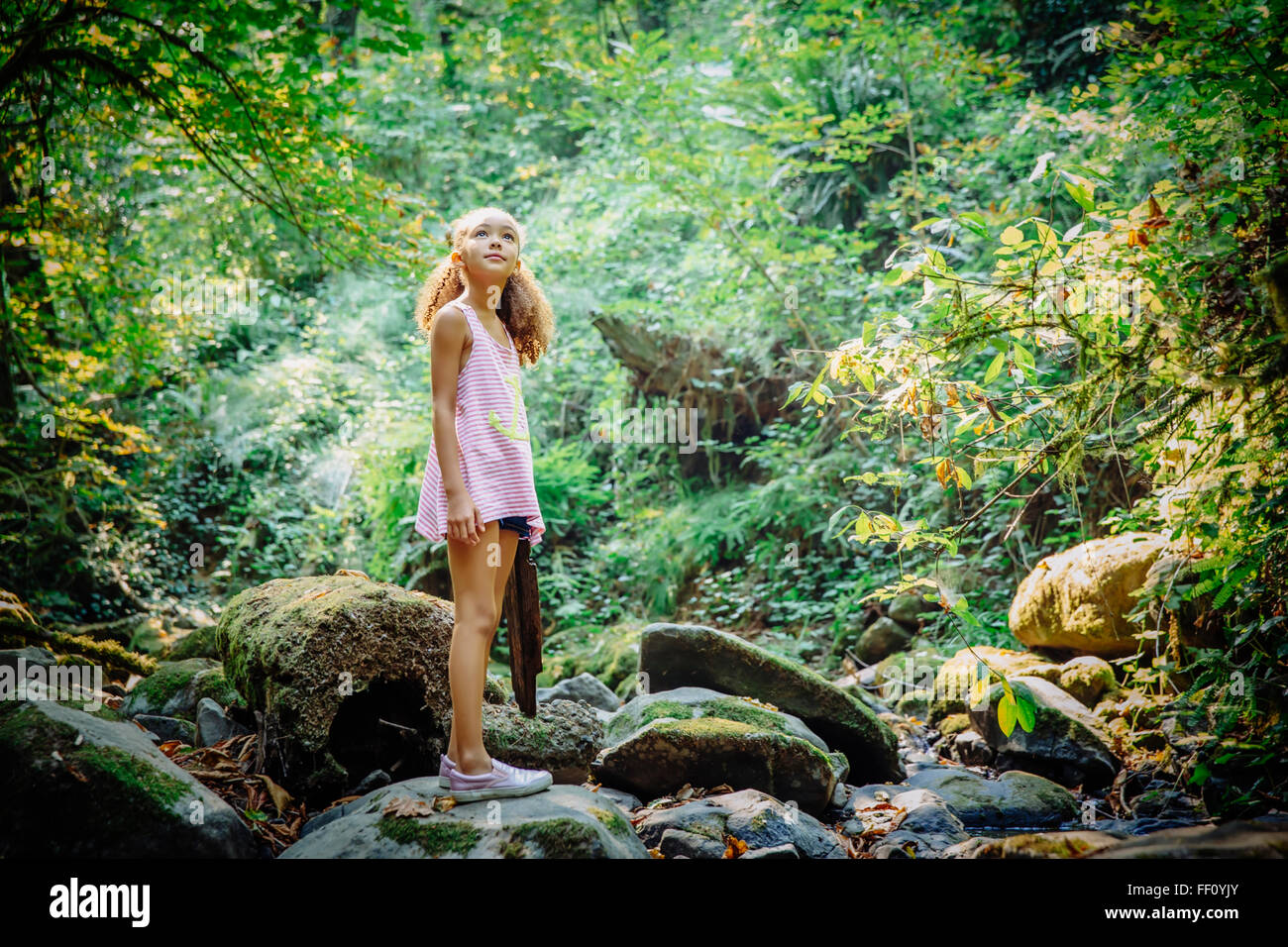 Mixed race girl exploring stream Stock Photo - Alamy