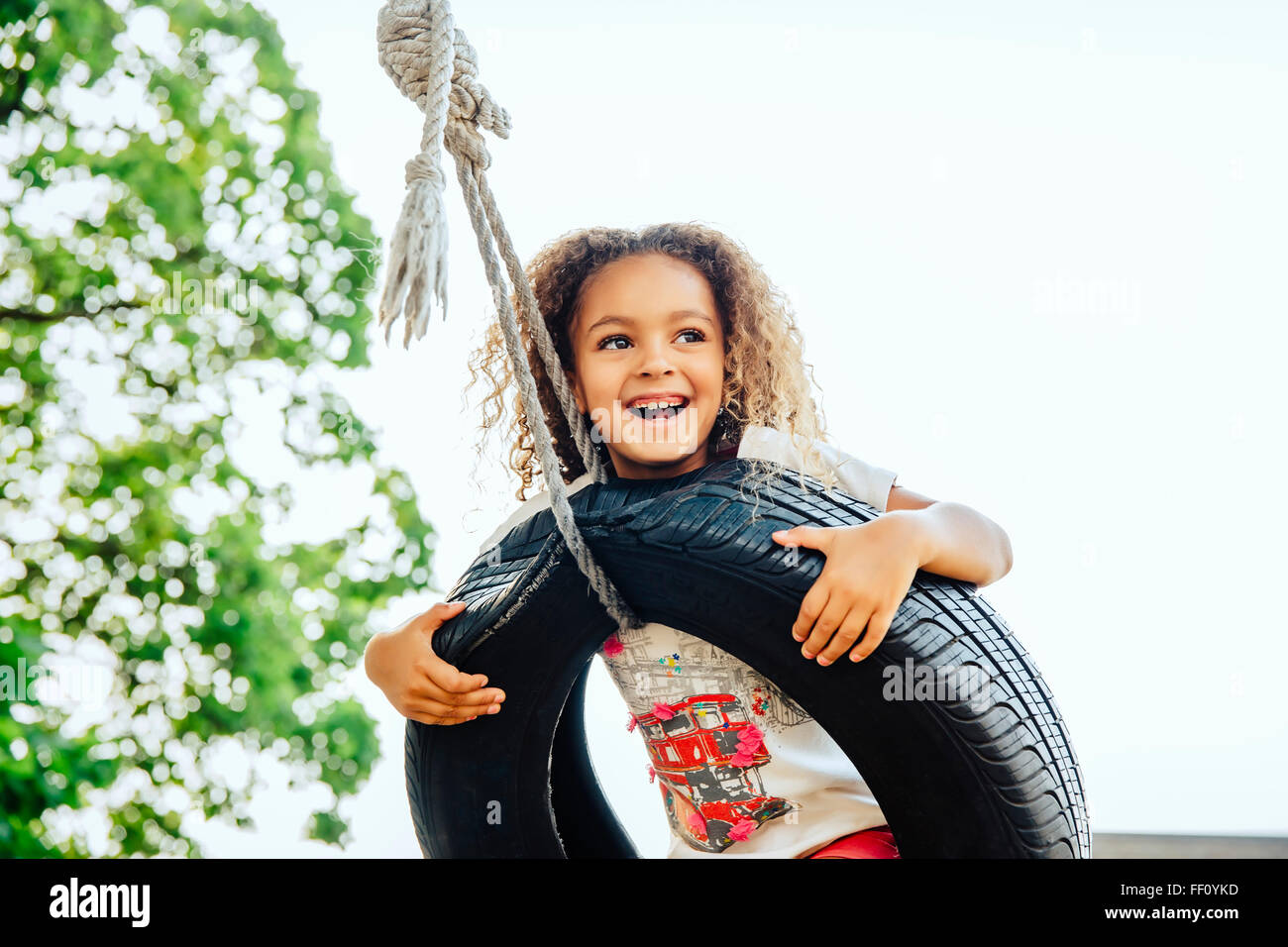 Girl tire swing hi-res stock photography and images - Alamy