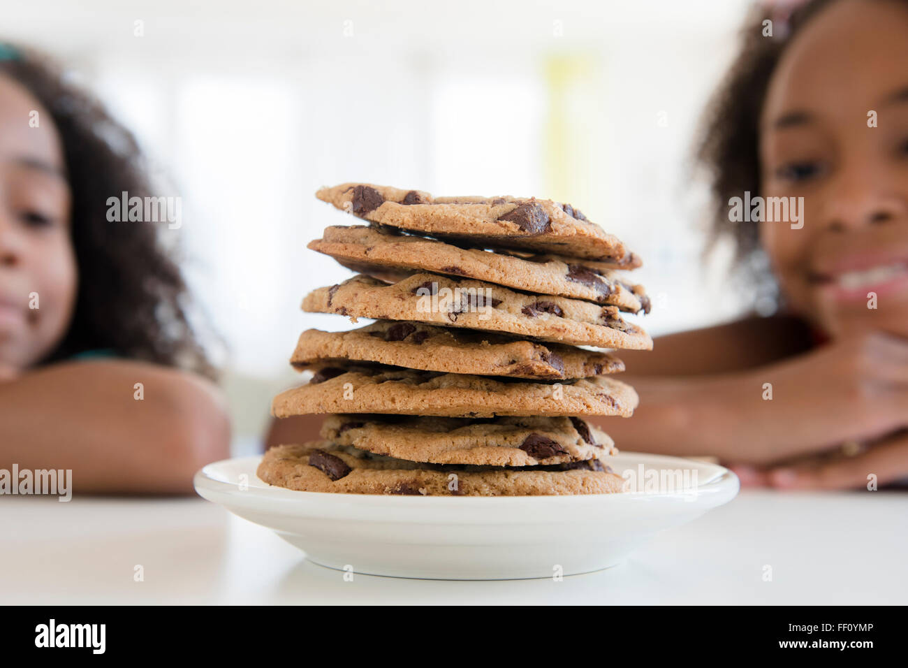 Two girls eating chocolate cookies hi-res stock photography and images ...