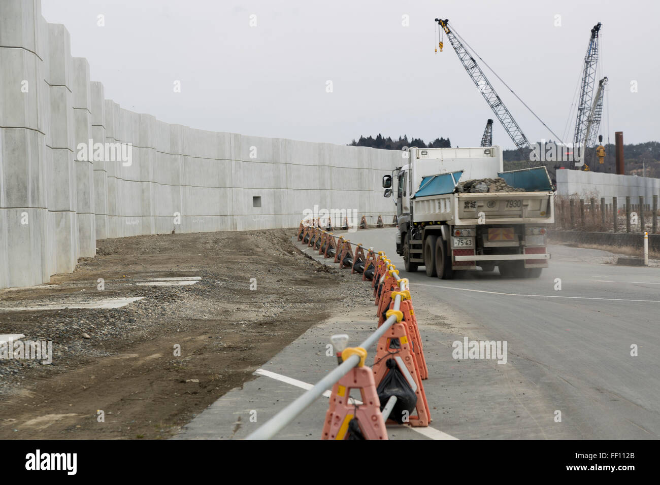 A construction truck runs next to a 1.61 km long tsunami barrier in ...