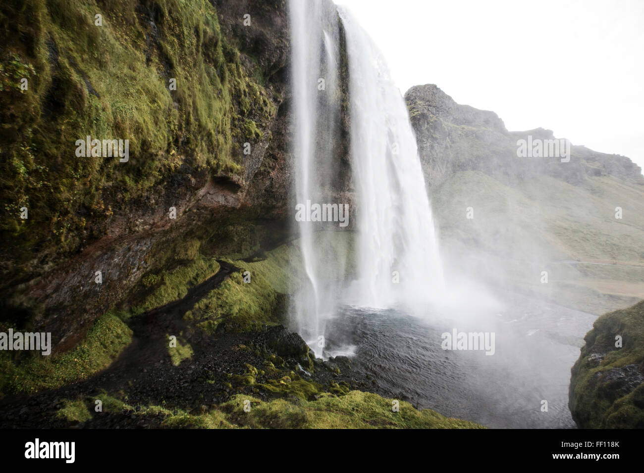 Waterfall over rock formation cliffs Stock Photo - Alamy