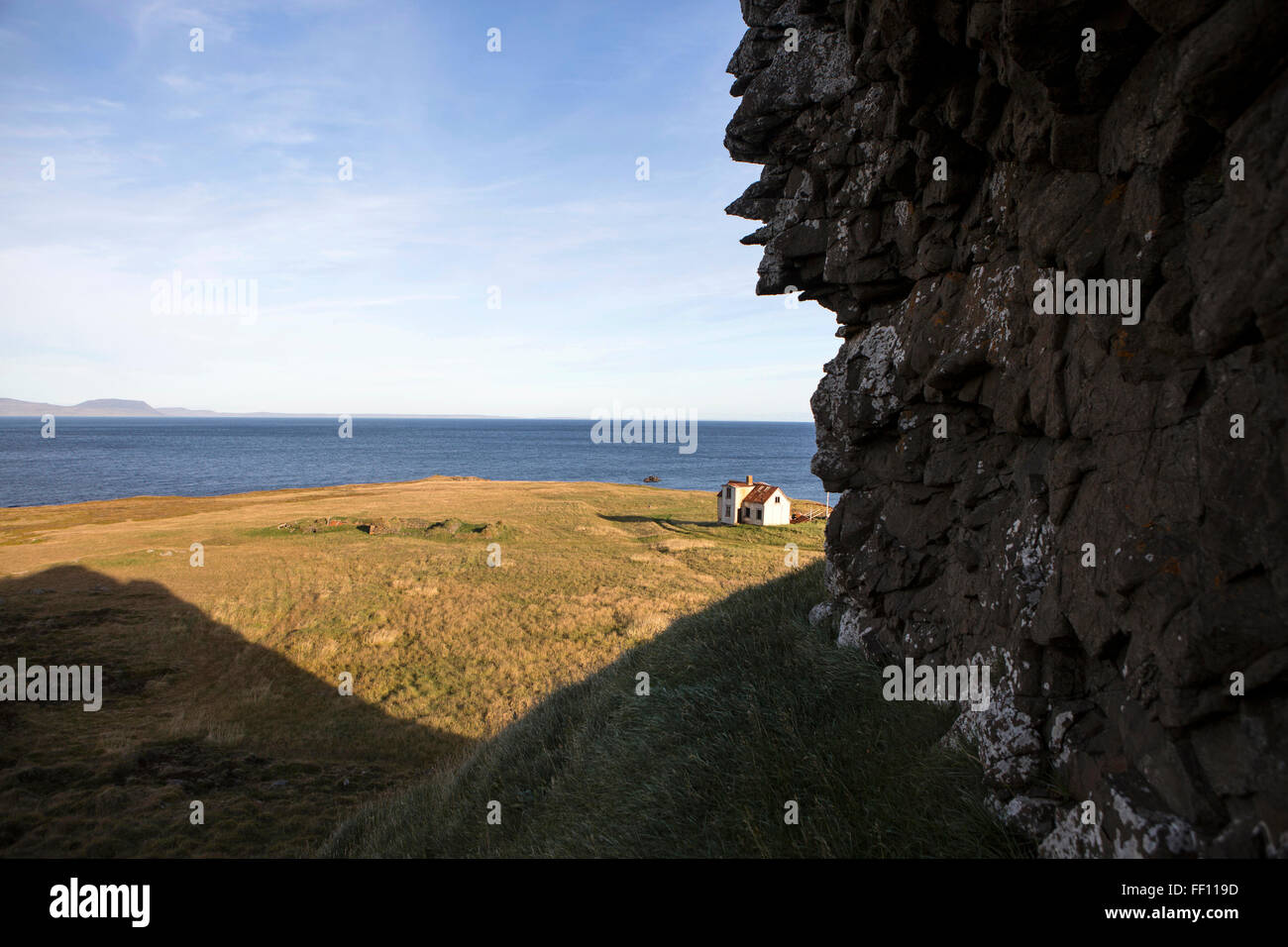 Rocky cliff over rural field and seascape Stock Photo - Alamy