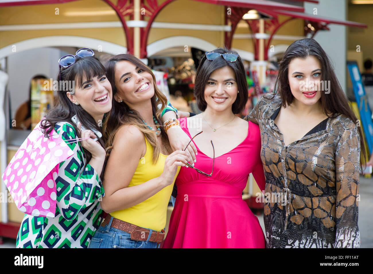 Smiling Hispanic women holding shopping bags Stock Photo - Alamy