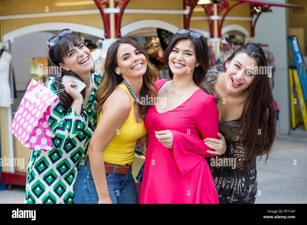 Smiling Hispanic women holding shopping bags Stock Photo - Alamy