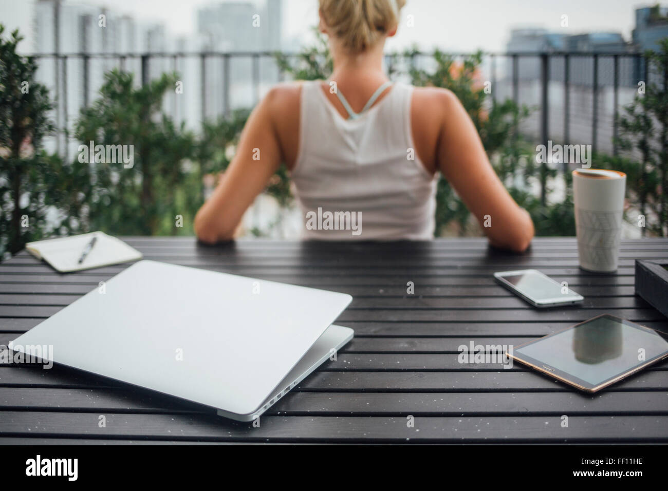 Blond woman sitting balcony hi-res stock photography and images - Alamy
