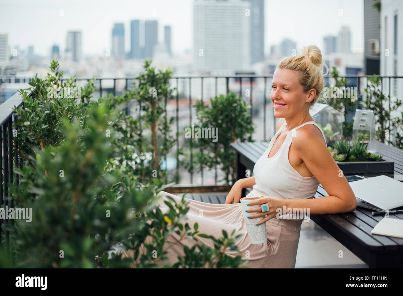 Beautiful blonde woman on balcony hi-res stock photography and images ...