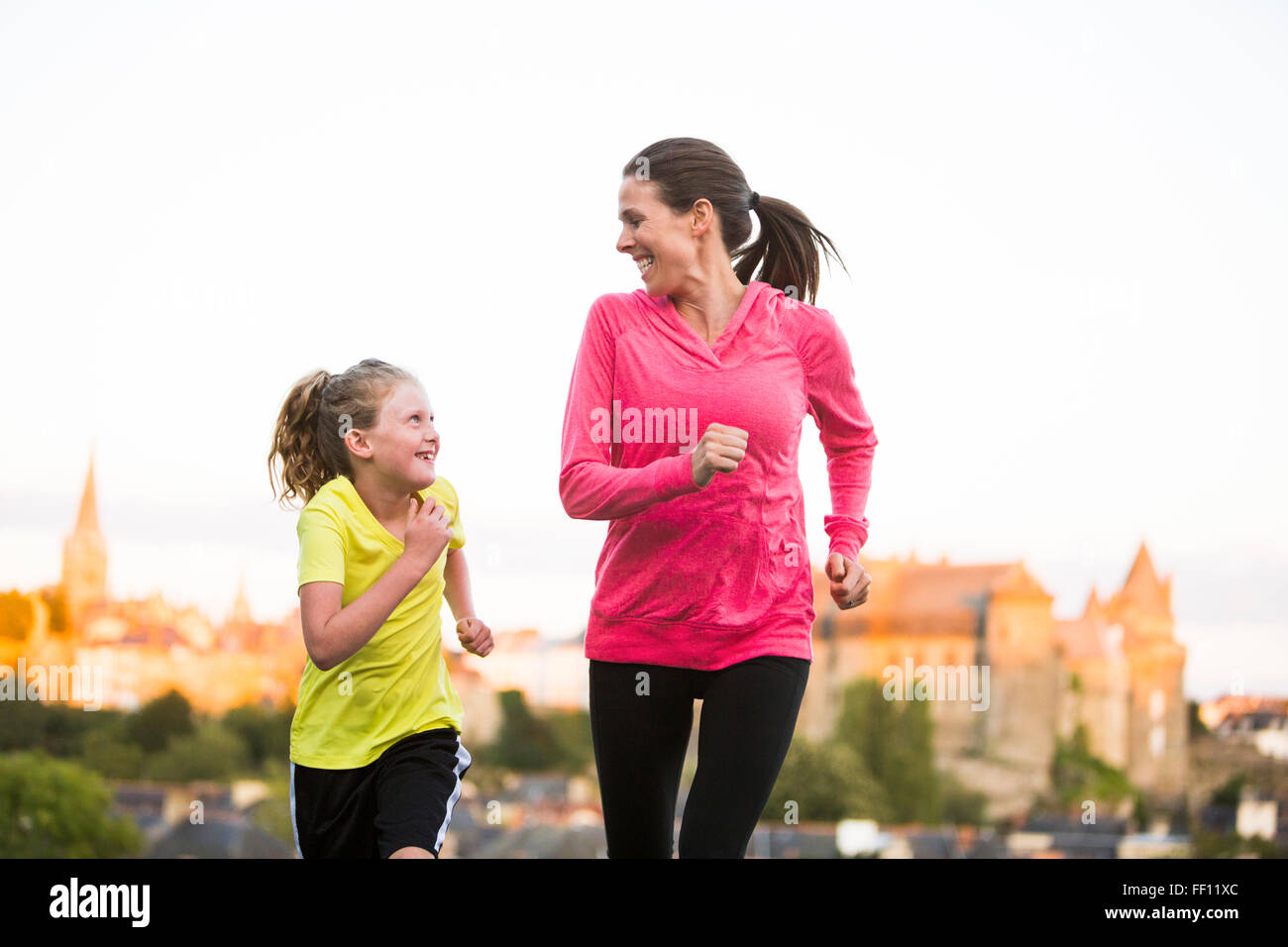 Caucasian mother and daughter jogging outdoors Stock Photo - Alamy