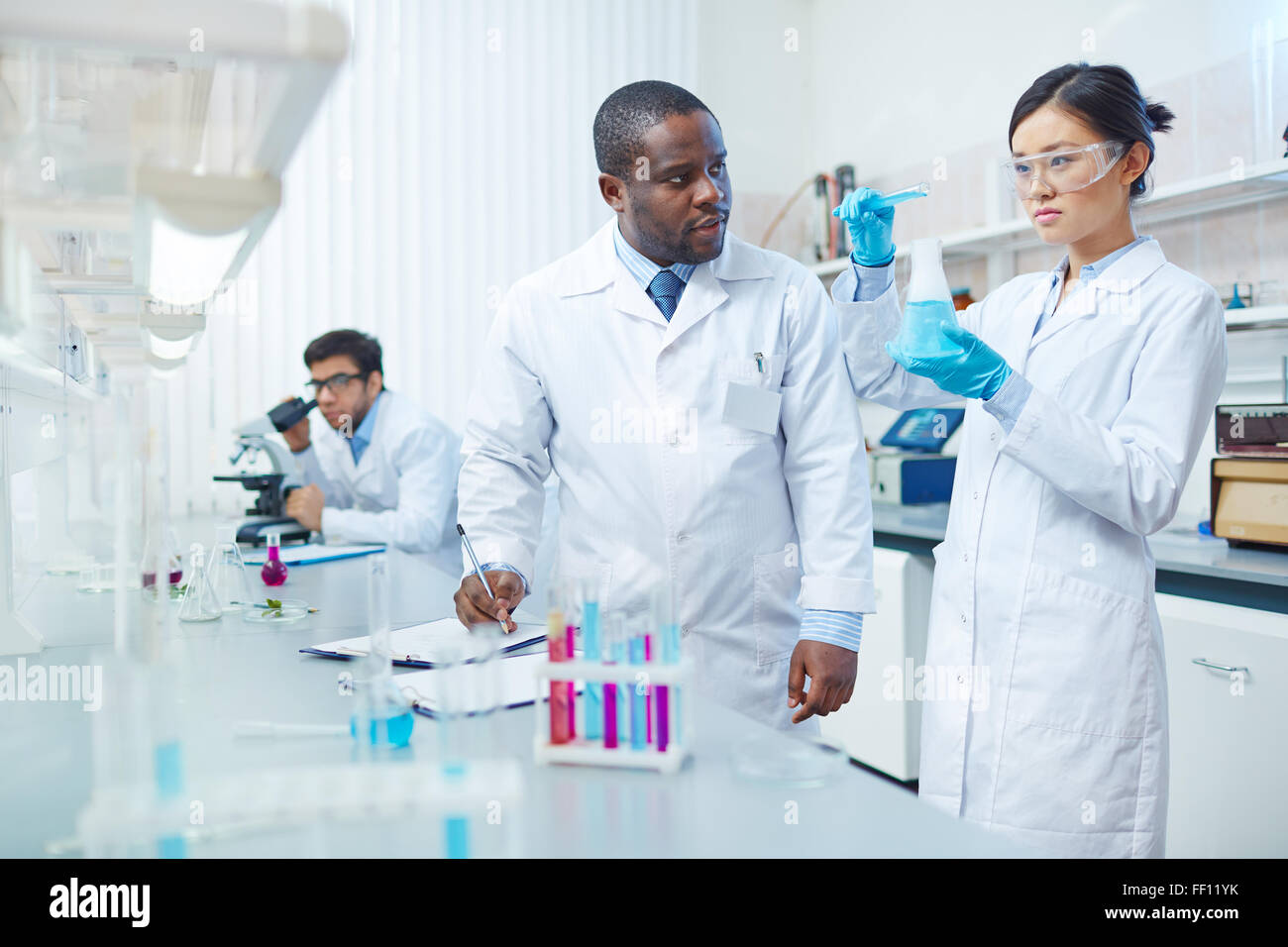 Young scientists analyzing new substance Stock Photo - Alamy