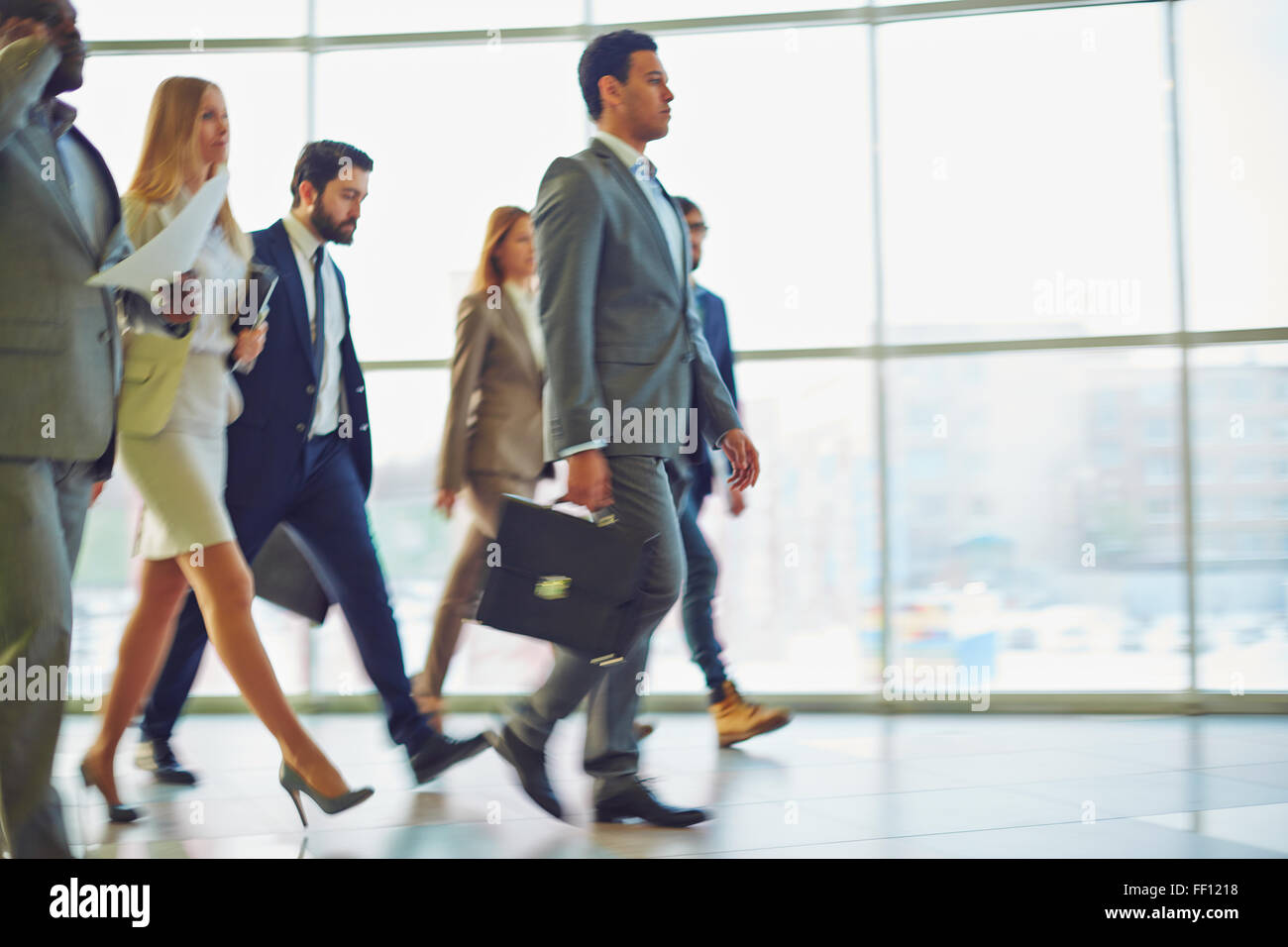 Modern business people walking to work Stock Photo - Alamy