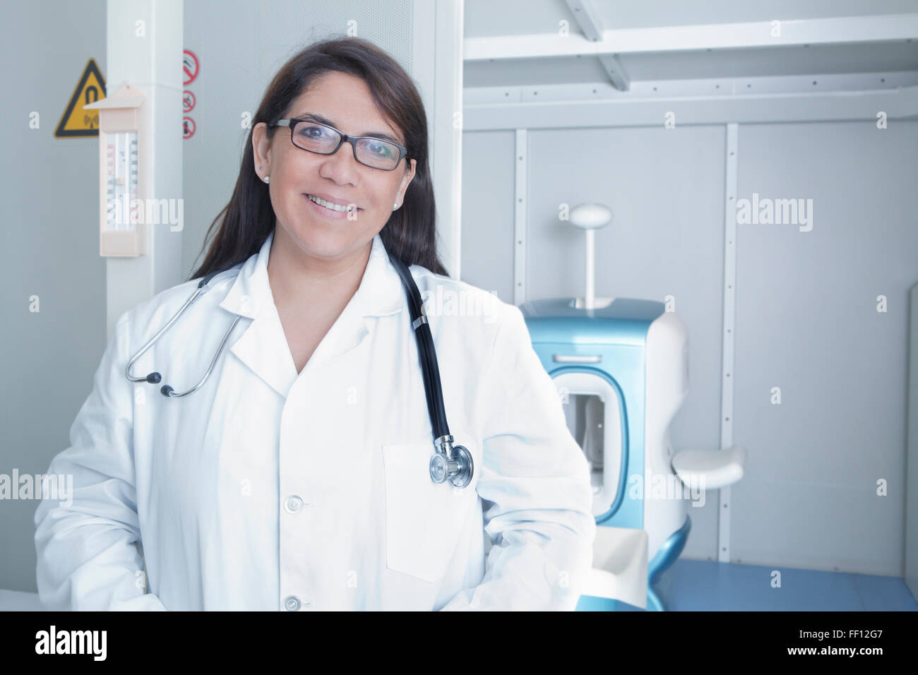 Hispanic doctor smiling in hospital Stock Photo - Alamy