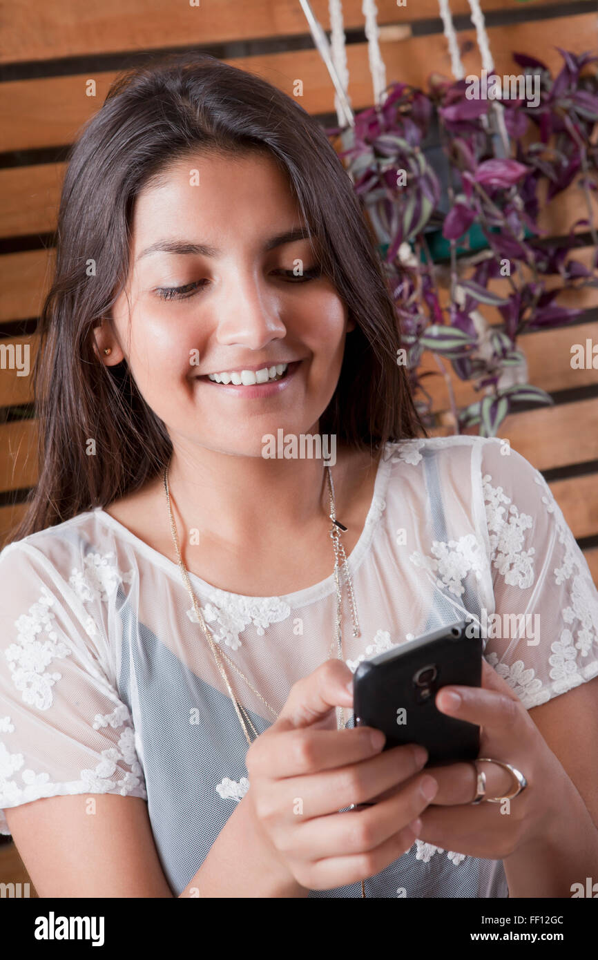 Hispanic woman using cell phone Stock Photo - Alamy