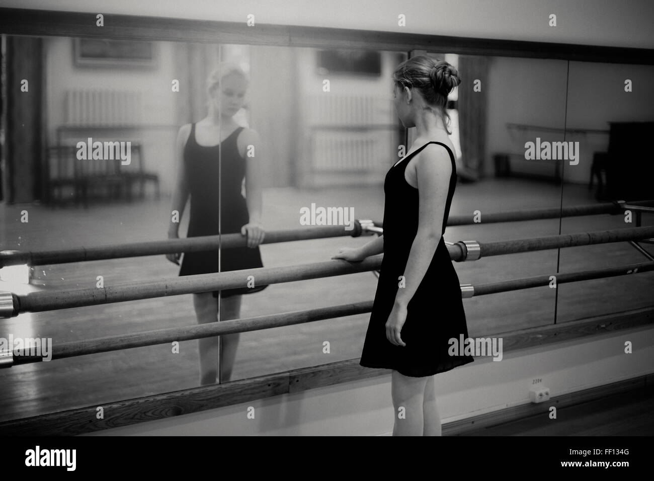 Caucasian ballerina standing at barre Stock Photo - Alamy