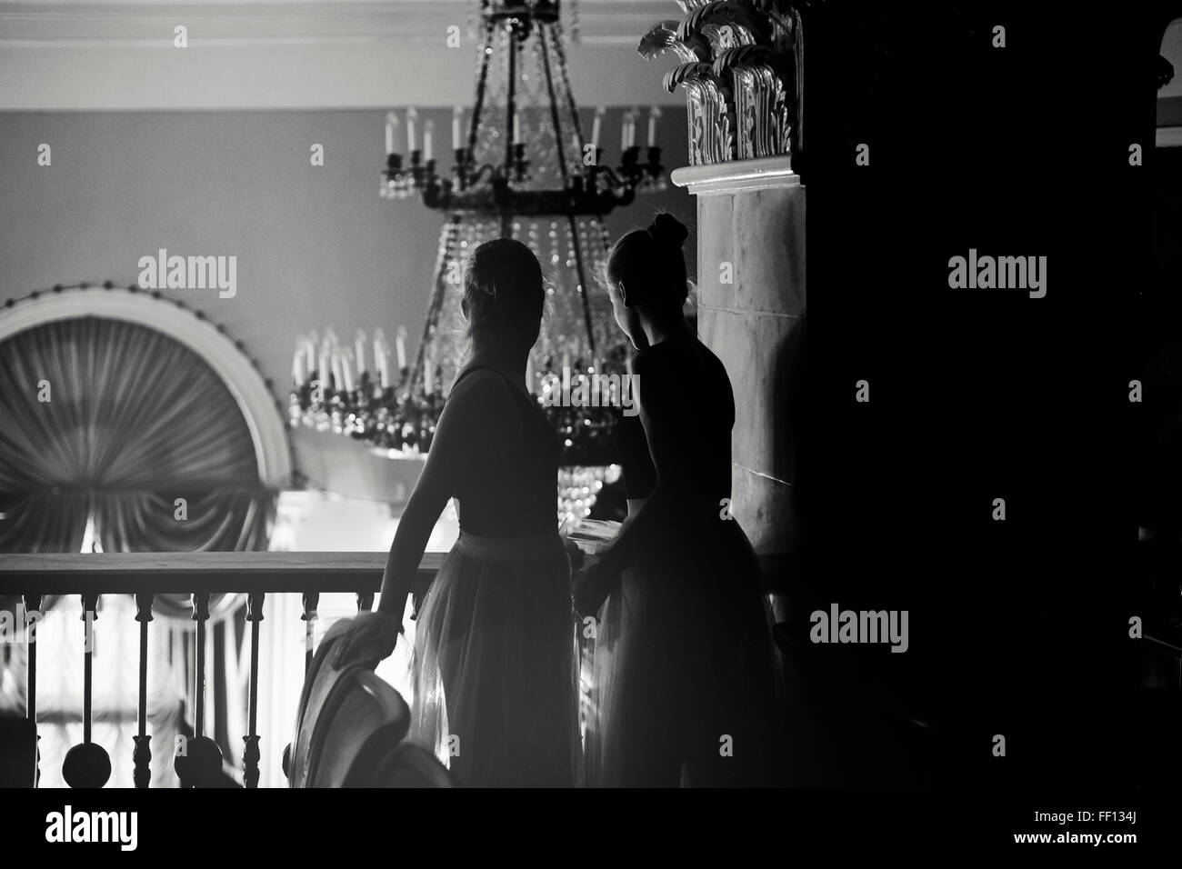 Caucasian teenage girls looking over balcony Stock Photo - Alamy