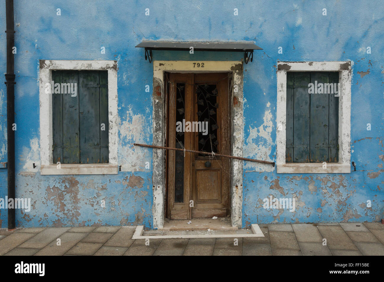 weathered blue house with barred door Stock Photo - Alamy
