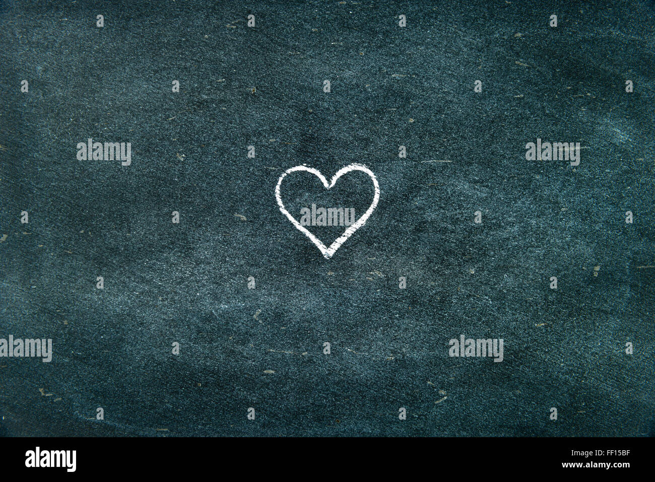 Hand drawing heart shape symbol on blackboard as design resource, copy ...