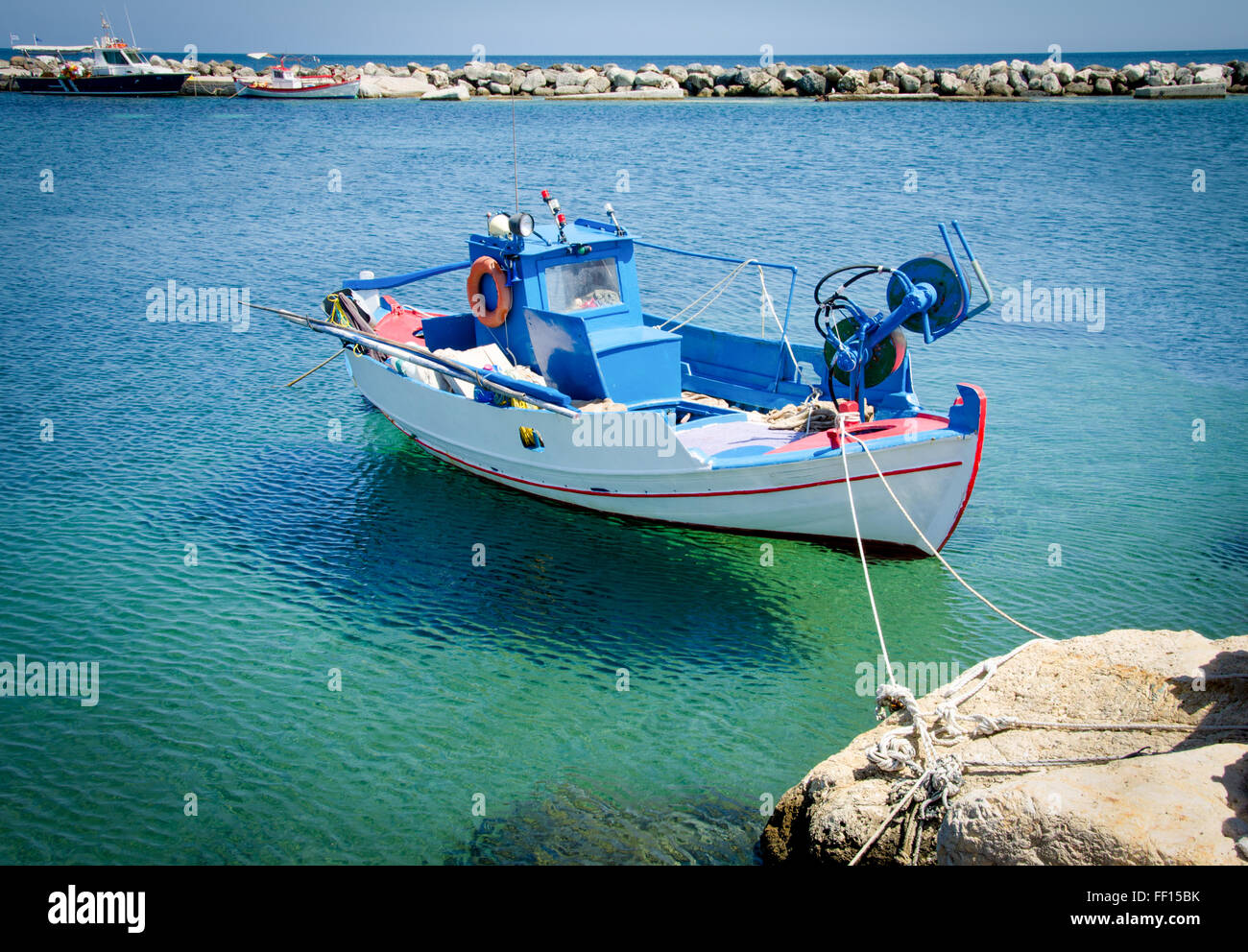 Small fishing wooden boat,floating in clear waters Stock Photo - Alamy