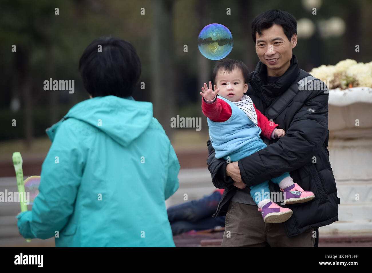 Wuhan, China's Hubei Province. 10th Feb, 2016. A child and his parent ...