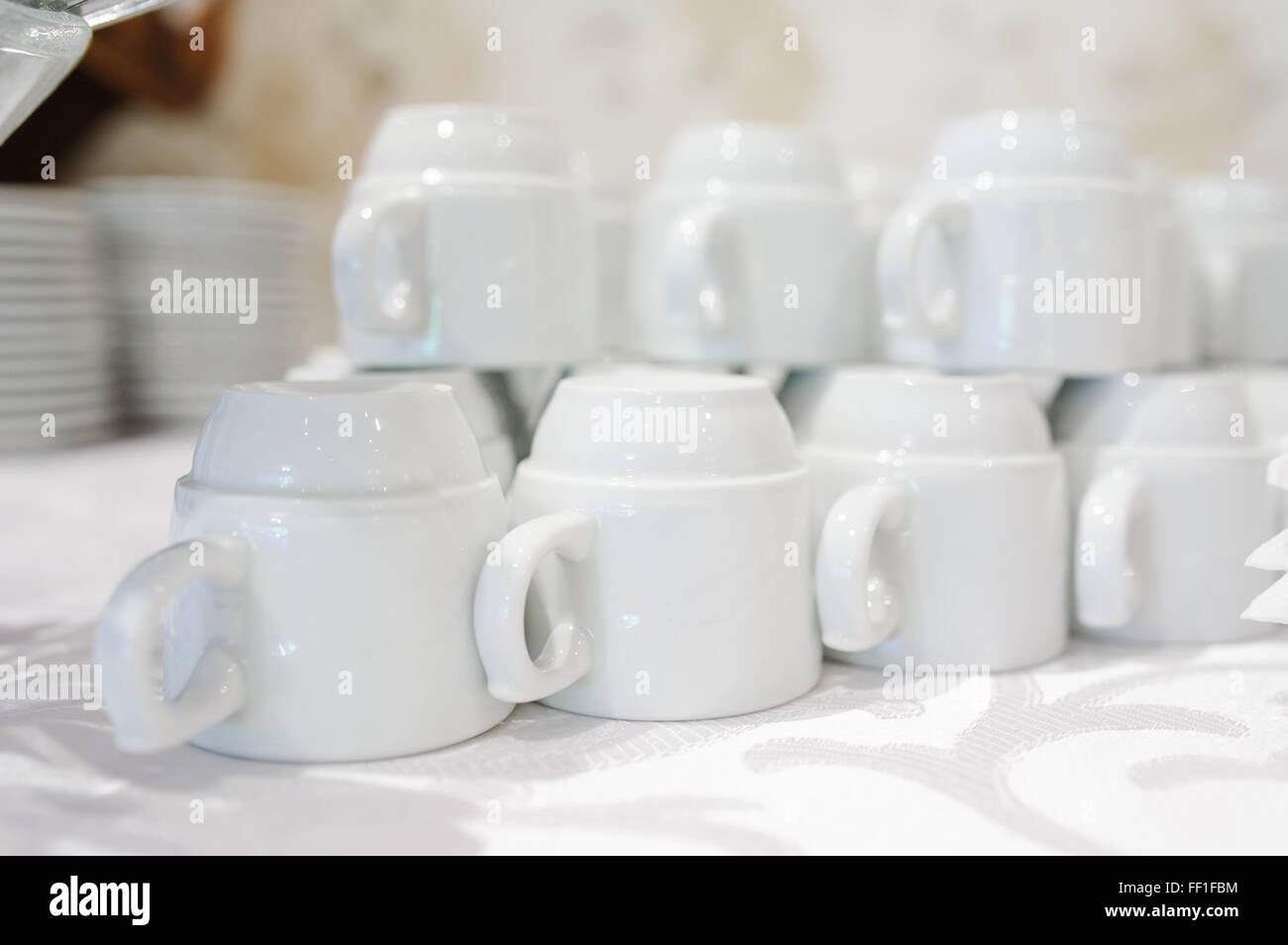 Stack of clean cups ready to be used on dinner Stock Photo - Alamy