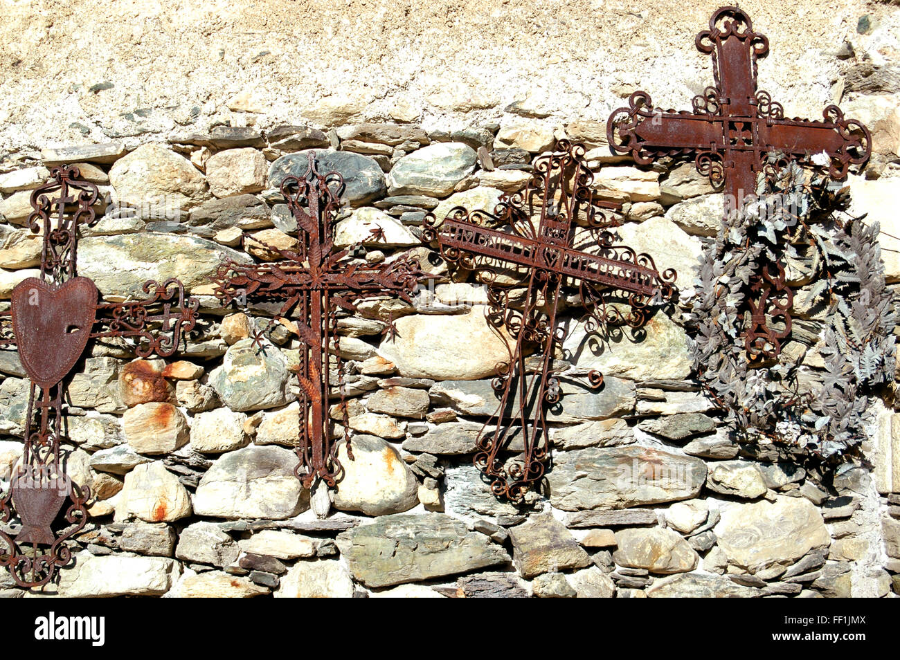 Iron gravemarkers Crosses on church wall, Acceglio, Valle Maira ...