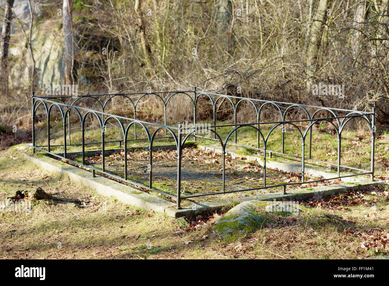 An old horizontal tombstone from 1771 surrounded by more modern fencing ...