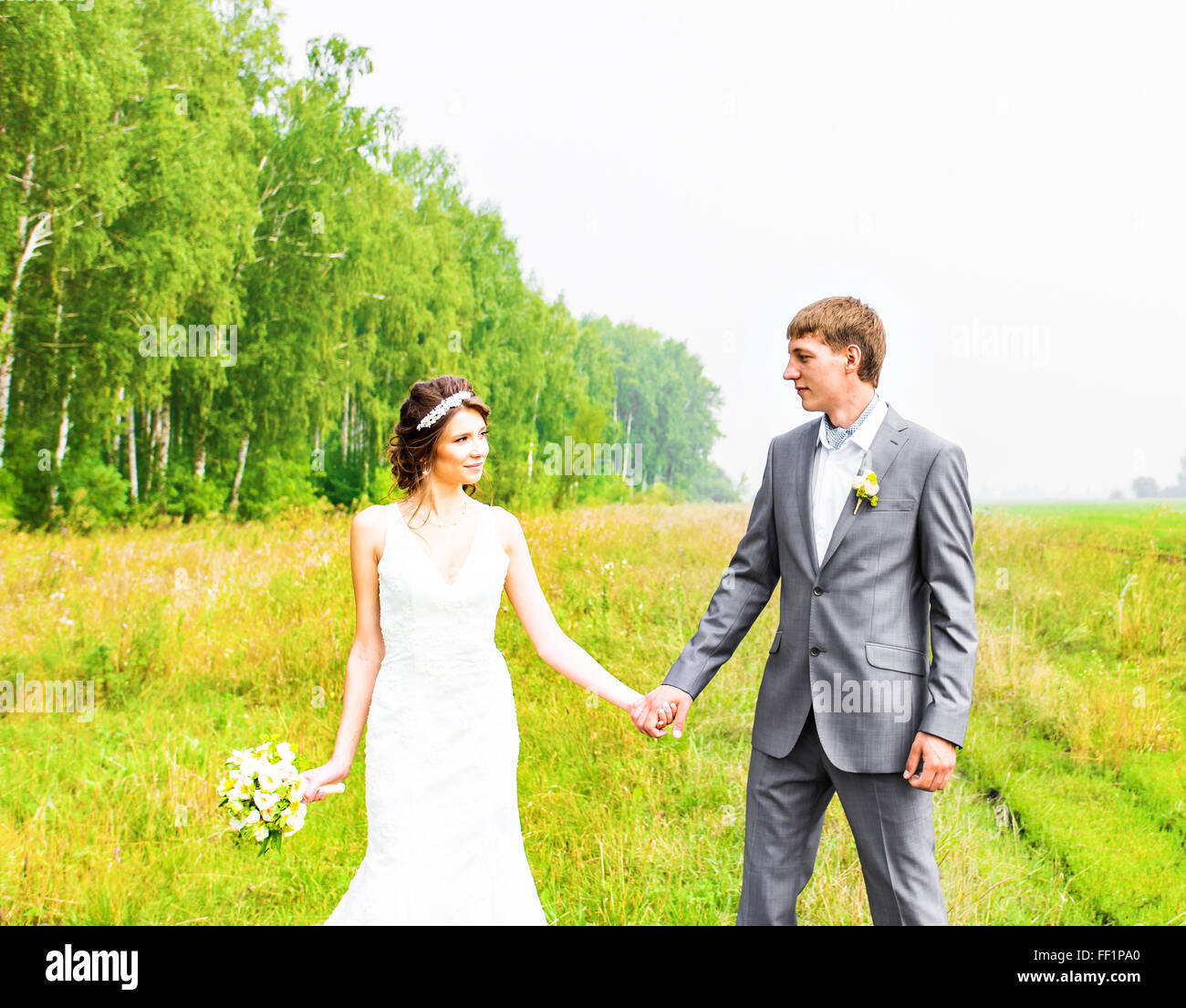 A young couple in love bride and groom, wedding day in summer. Enjoy a ...