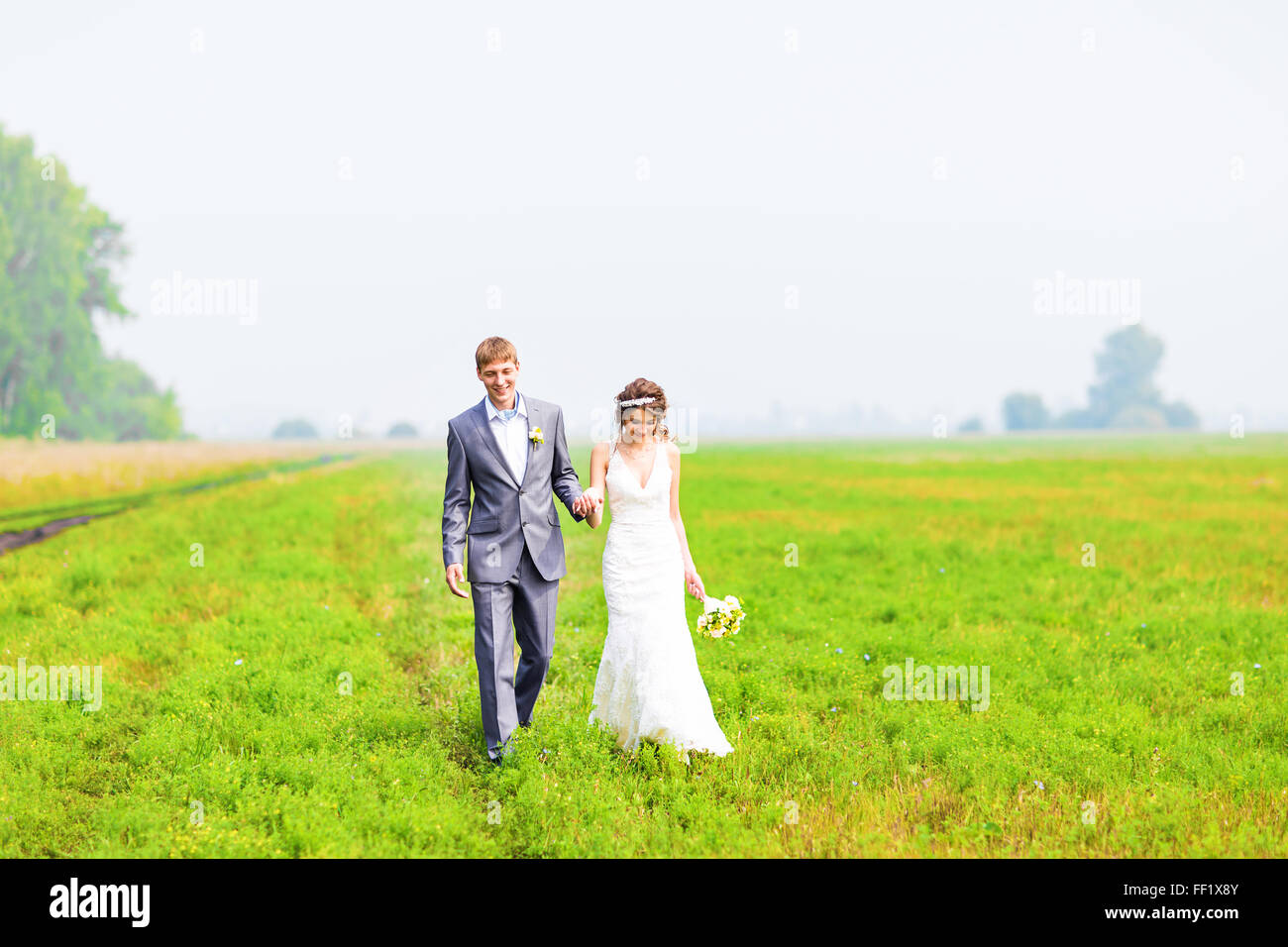 A young couple in love bride and groom, wedding day in summer. Enjoy a ...