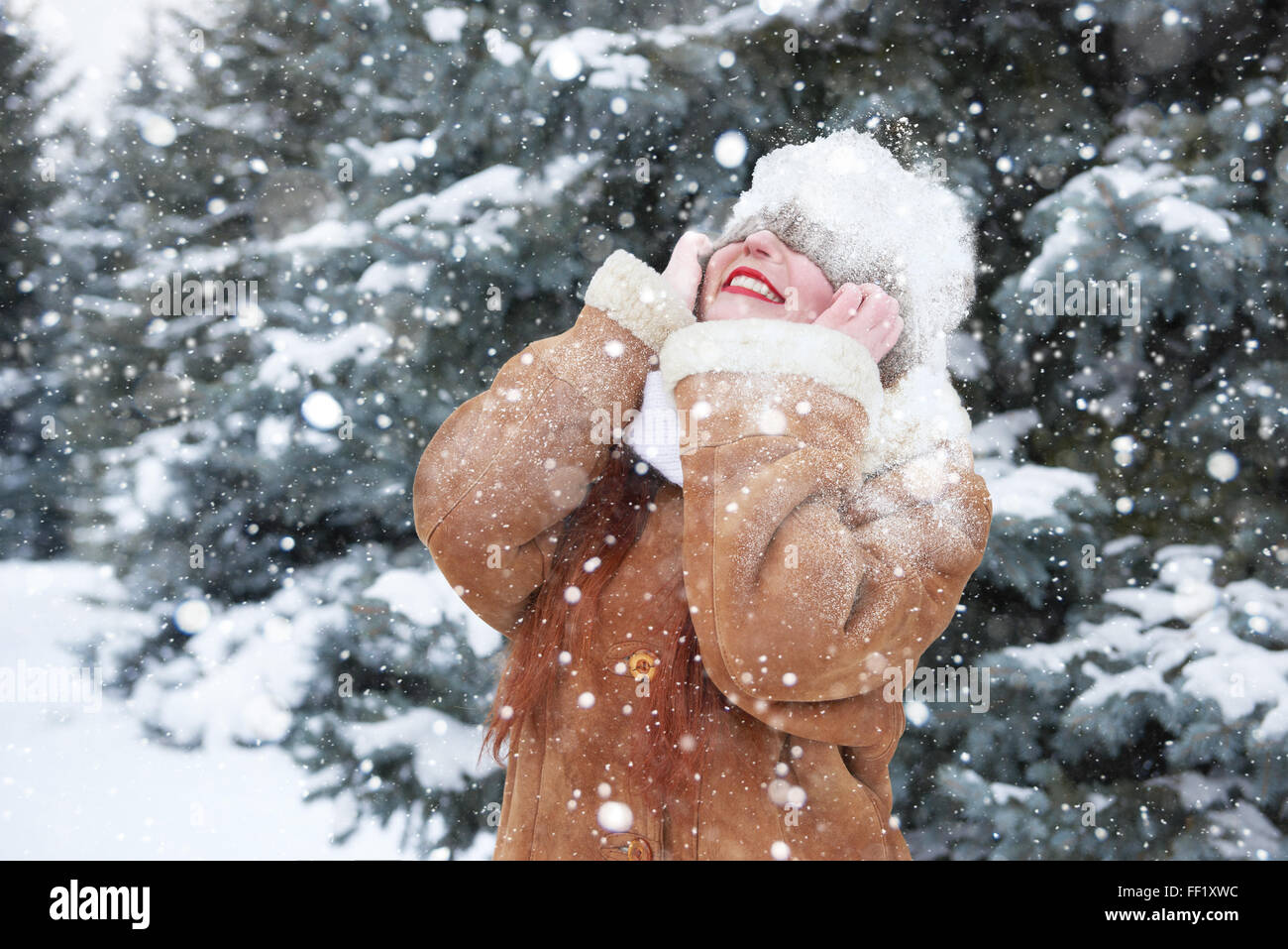Winter woman outdoor portrait with snow on head, snowy fir trees ...