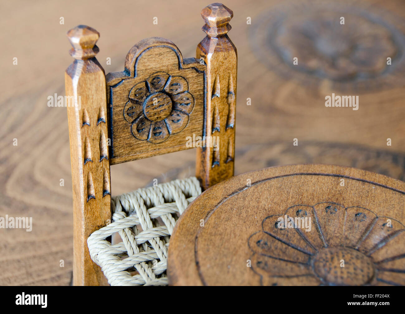 Mini wooden hand made chair on carved table Stock Photo - Alamy