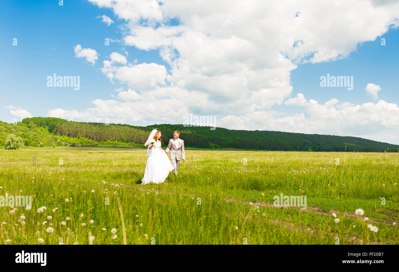 A young couple in love bride and groom, wedding day in summer. Enjoy a ...