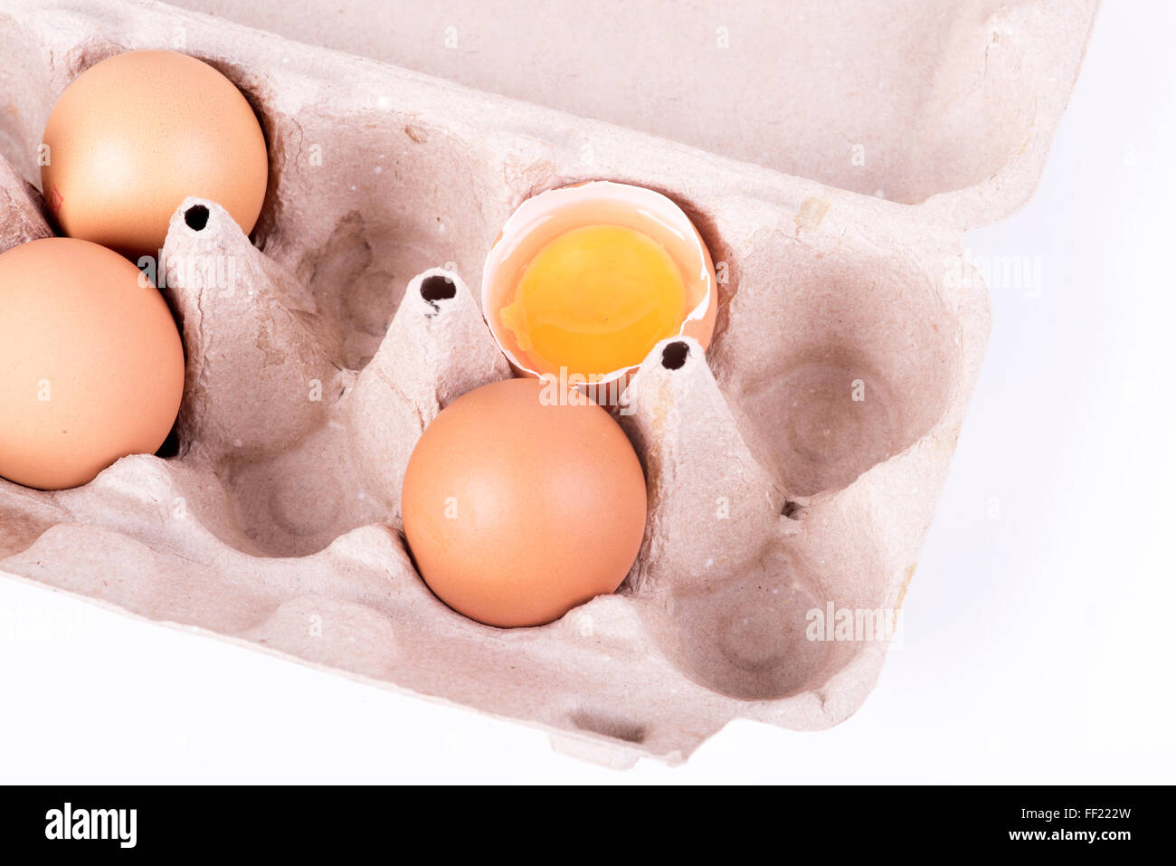 broken egg in a container with egg yolk Stock Photo - Alamy