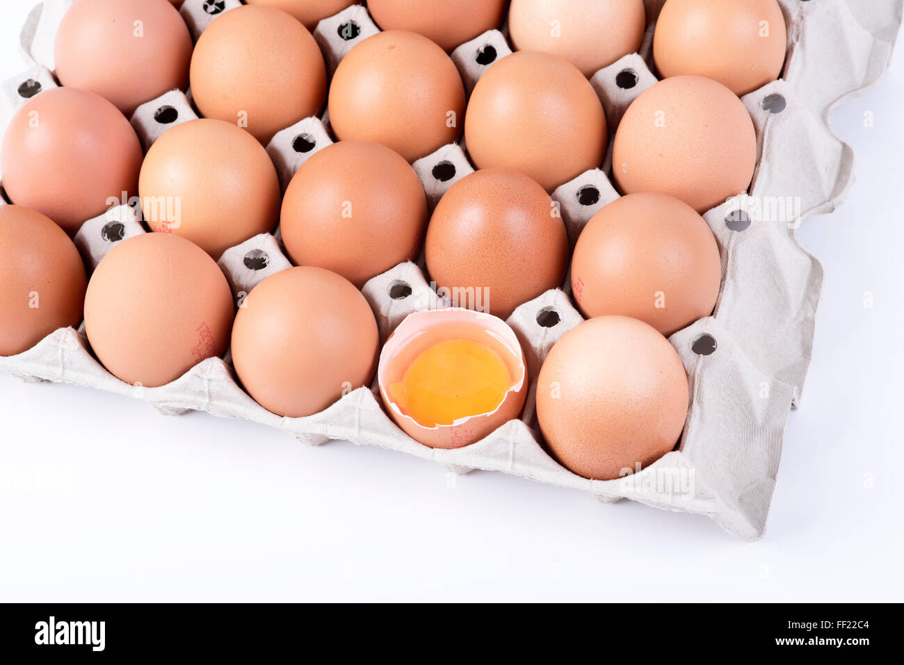 broken egg in a container with egg yolk Stock Photo - Alamy
