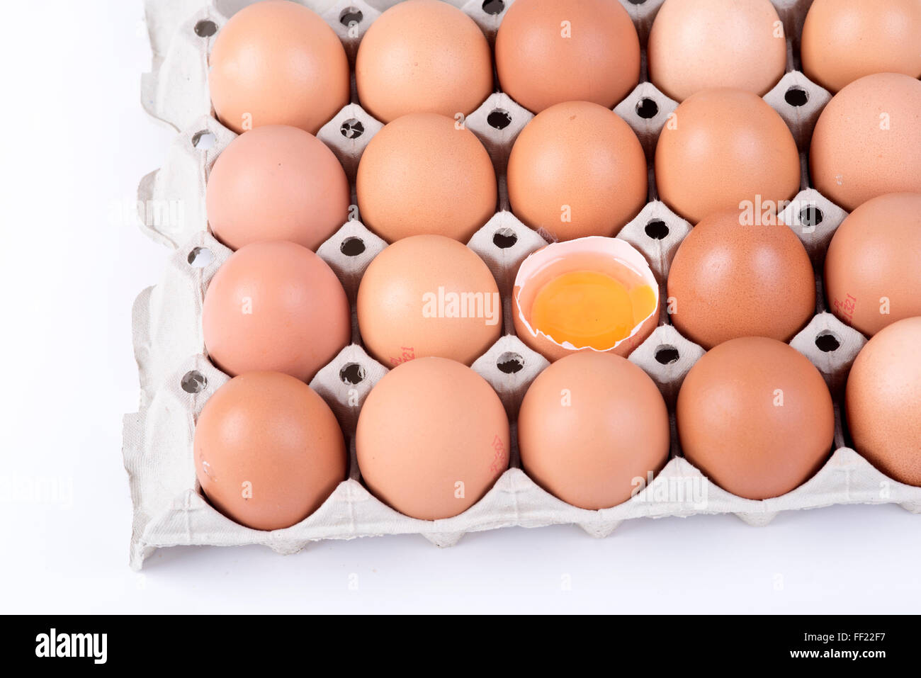 broken egg in a container with egg yolk Stock Photo - Alamy