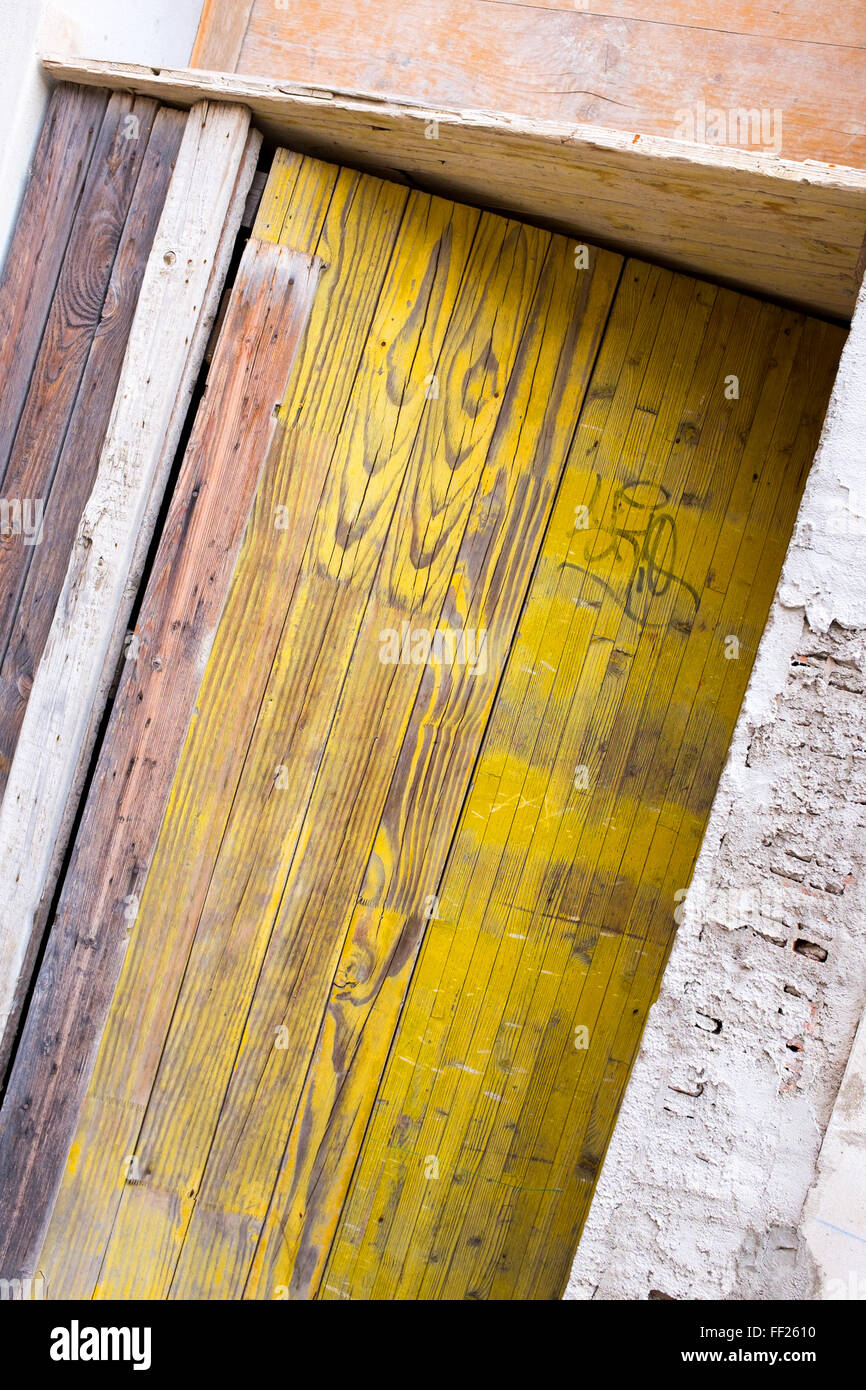 Rustic yellow door partially open hi-res stock photography and images ...