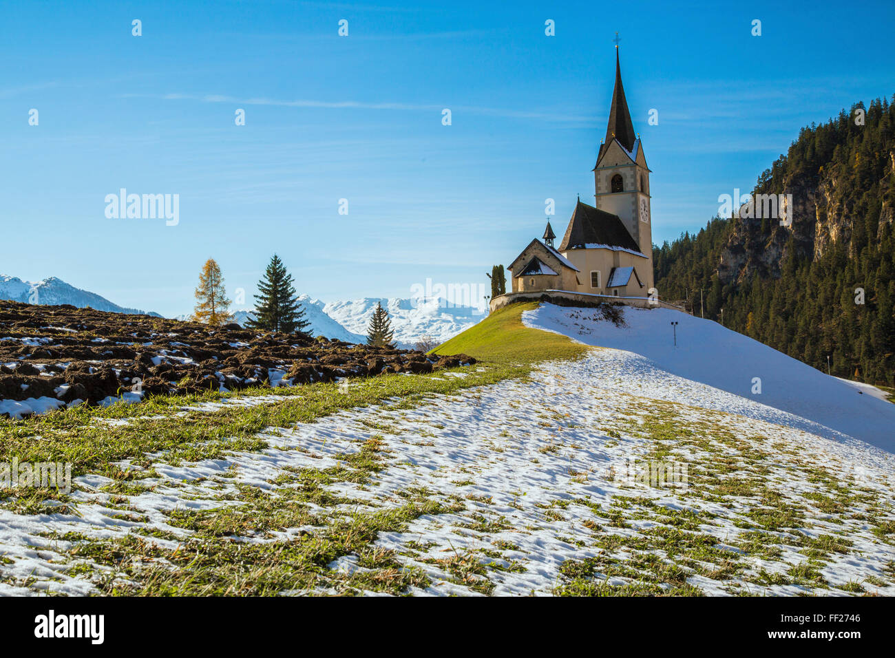 The church of the little village of Schmitten surrounded by snow ...