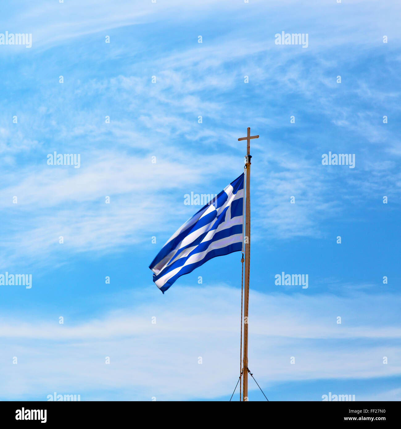 waving greece flag in the blue sky and flagpole Stock Photo - Alamy