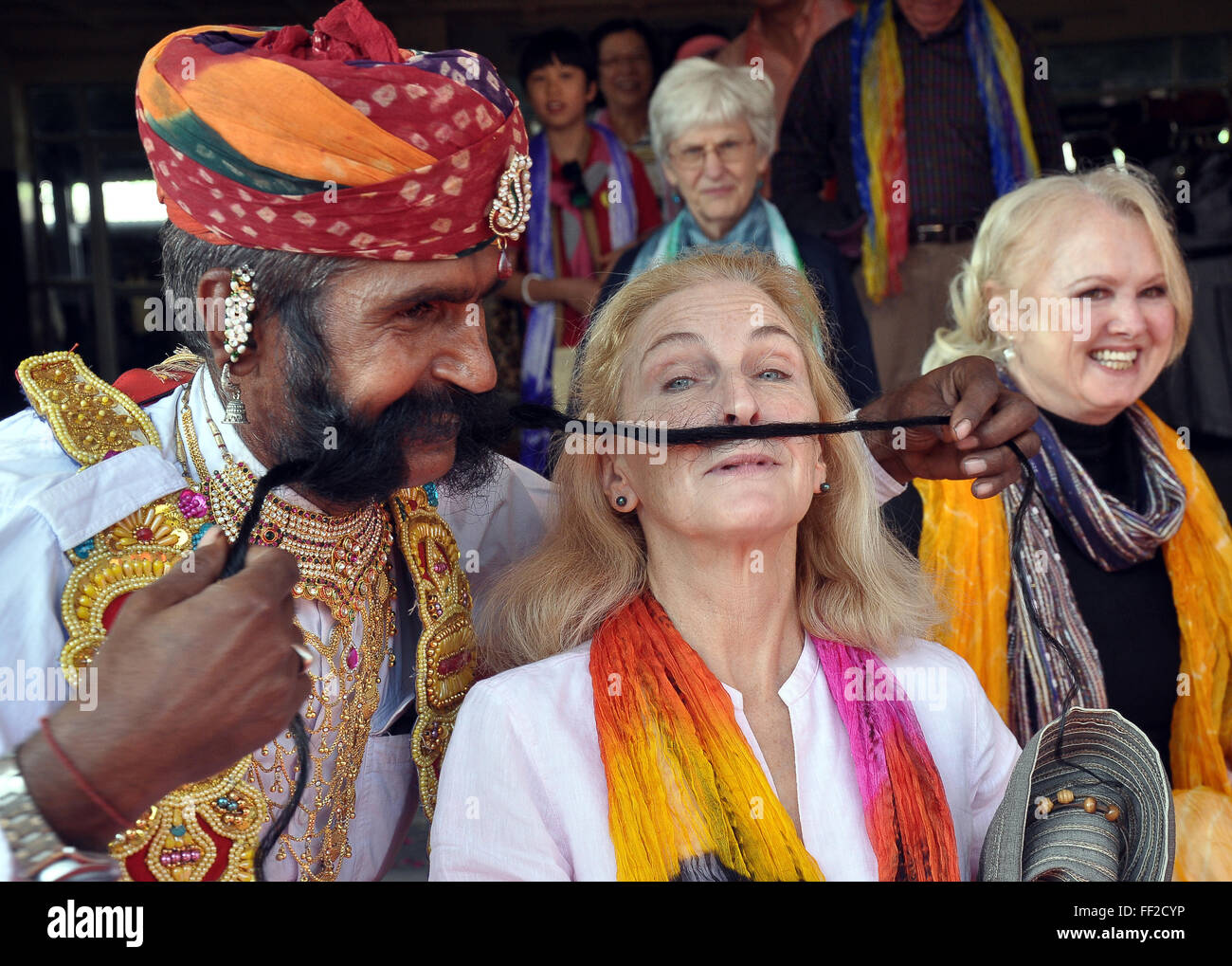 A Rajasthani artist showing his long moustache to entertain tourists on ...