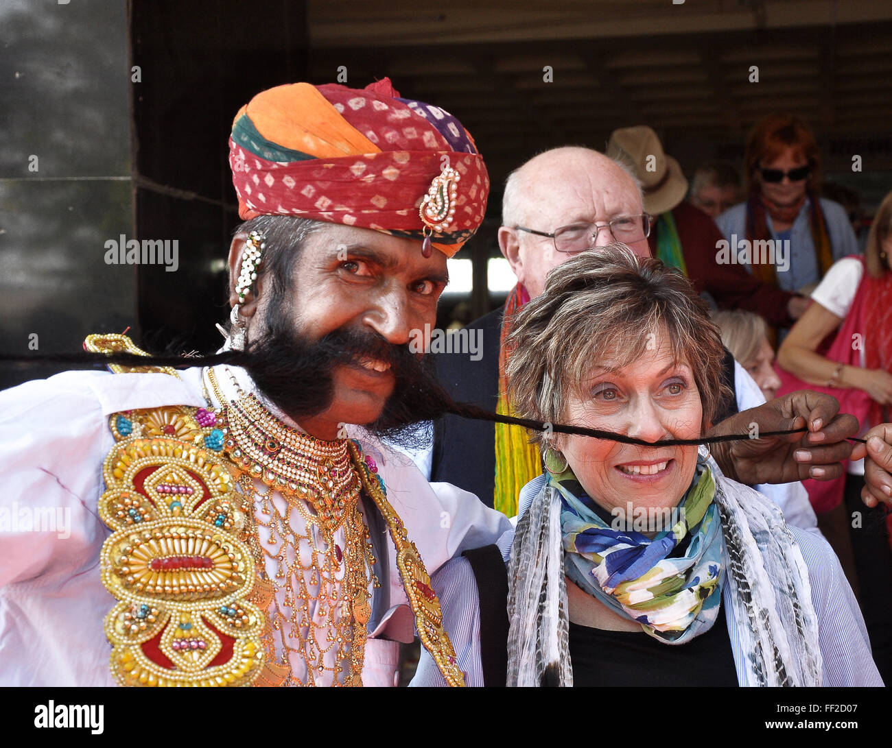 A Rajasthani artist showing his long moustache to entertain tourists on ...