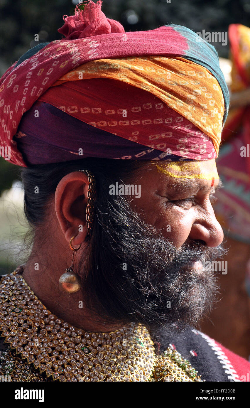 A Rajasthani artist showing his long moustache to entertain tourists on ...