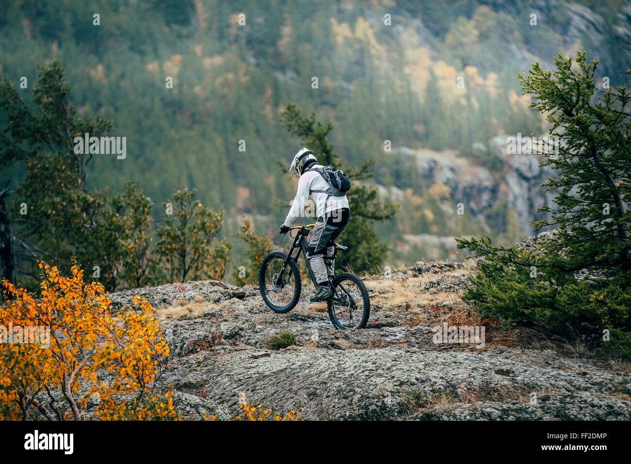 racer on a bike stopped at the edge of the mountain Stock Photo - Alamy