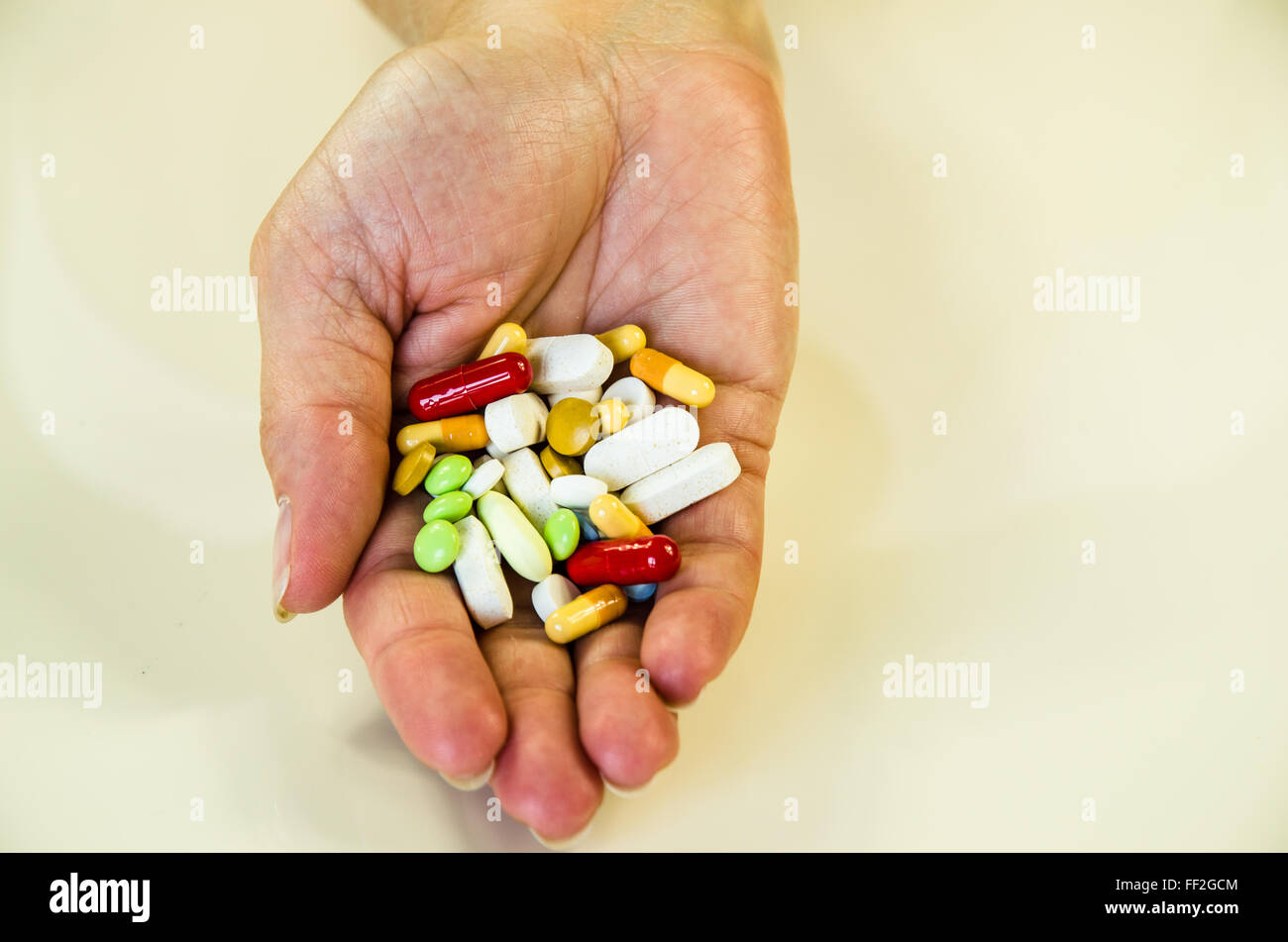 human hand full of colorful pills Stock Photo - Alamy