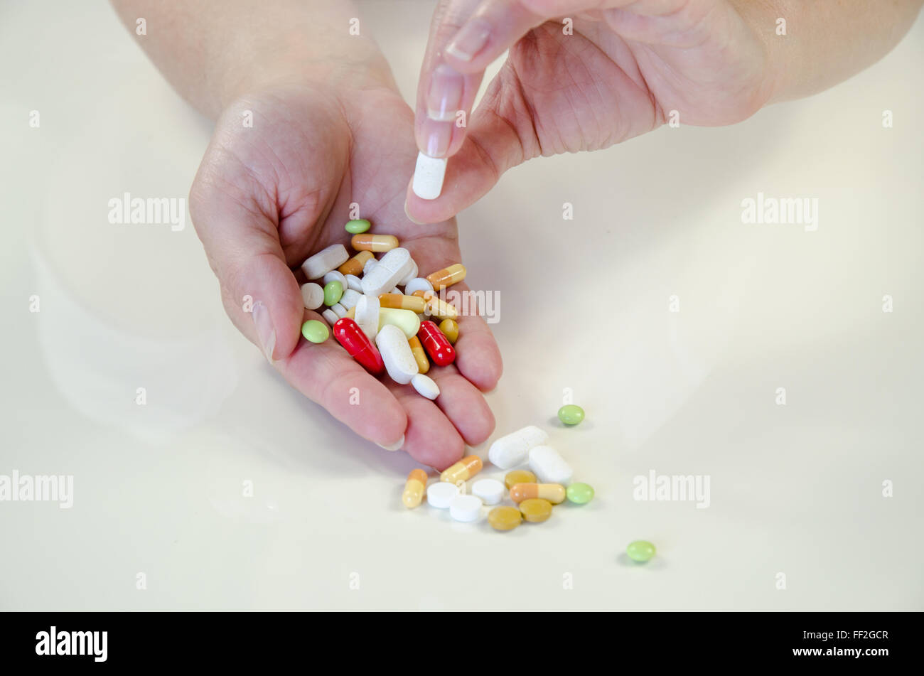 human hand full of colorful pills Stock Photo - Alamy